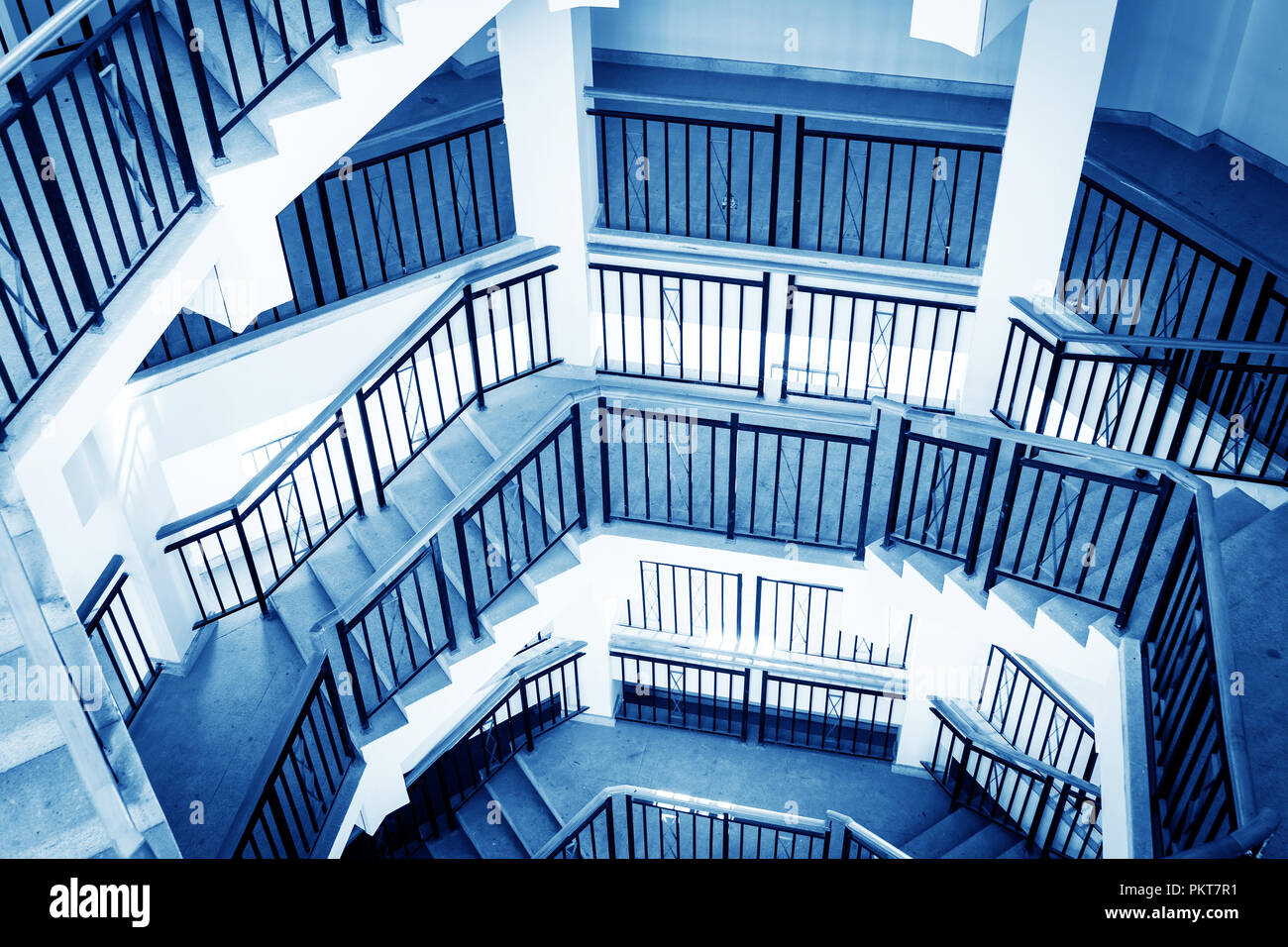 Rotating stairs, blue toned illustration Stock Photo - Alamy