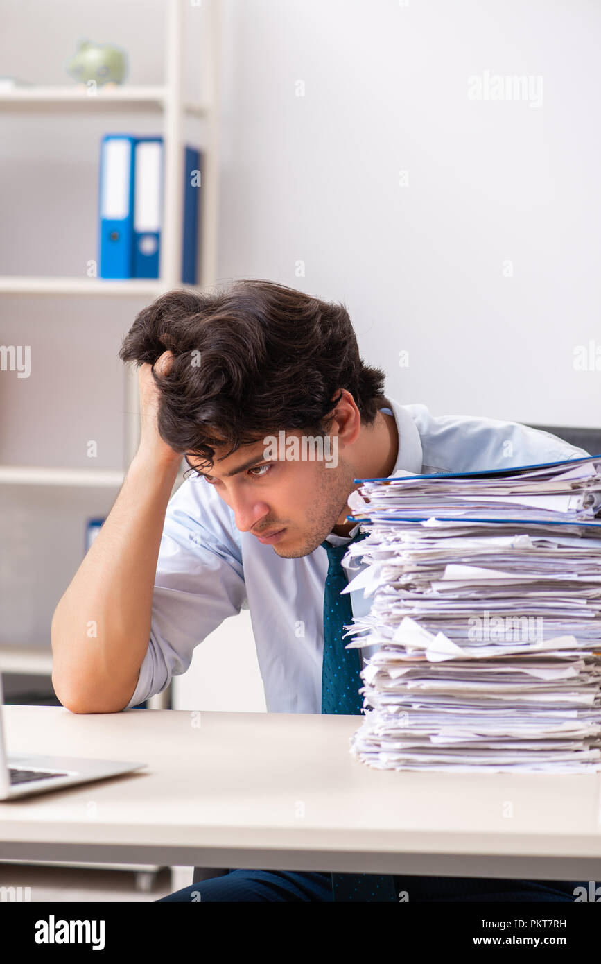 Overloaded busy employee with too much work and paperwork Stock Photo ...