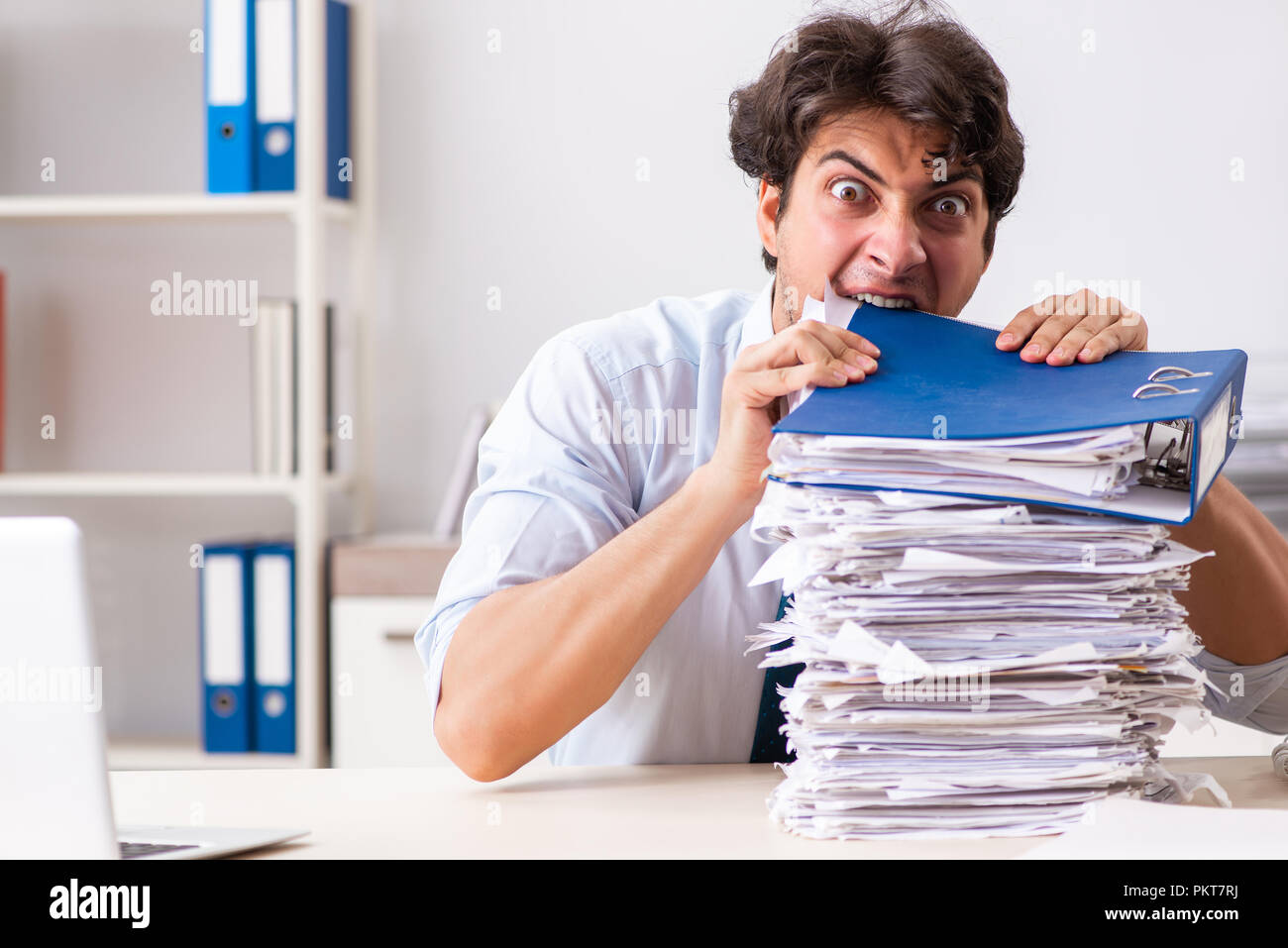 Overloaded busy employee with too much work and paperwork Stock Photo ...