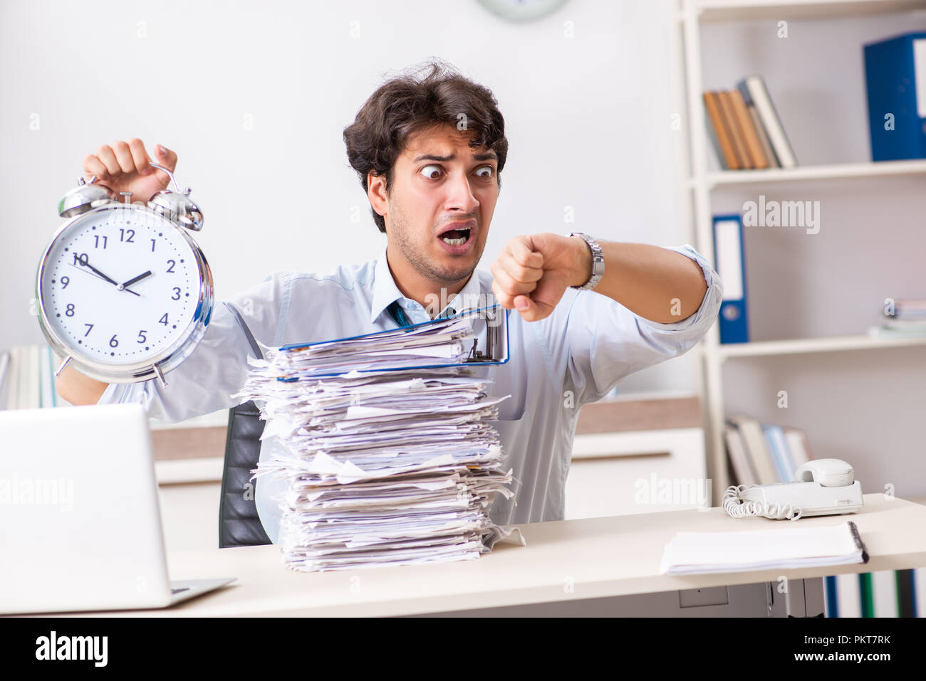Overloaded busy employee with too much work and paperwork Stock Photo ...