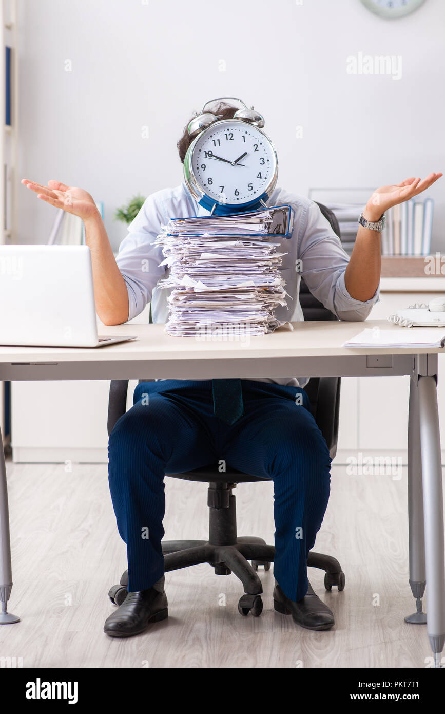 Overloaded busy employee with too much work and paperwork Stock Photo ...