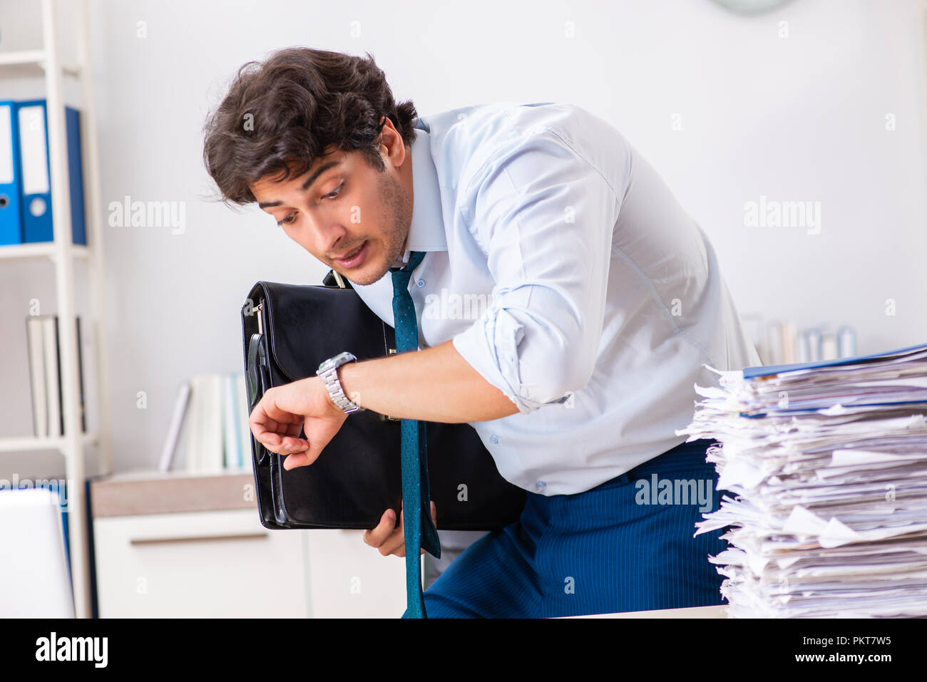 Overloaded busy employee with too much work and paperwork Stock Photo ...