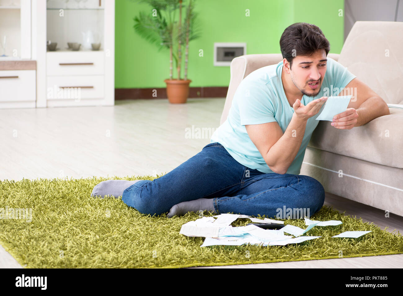 Young man struggling with personal finance and bills Stock Photo - Alamy