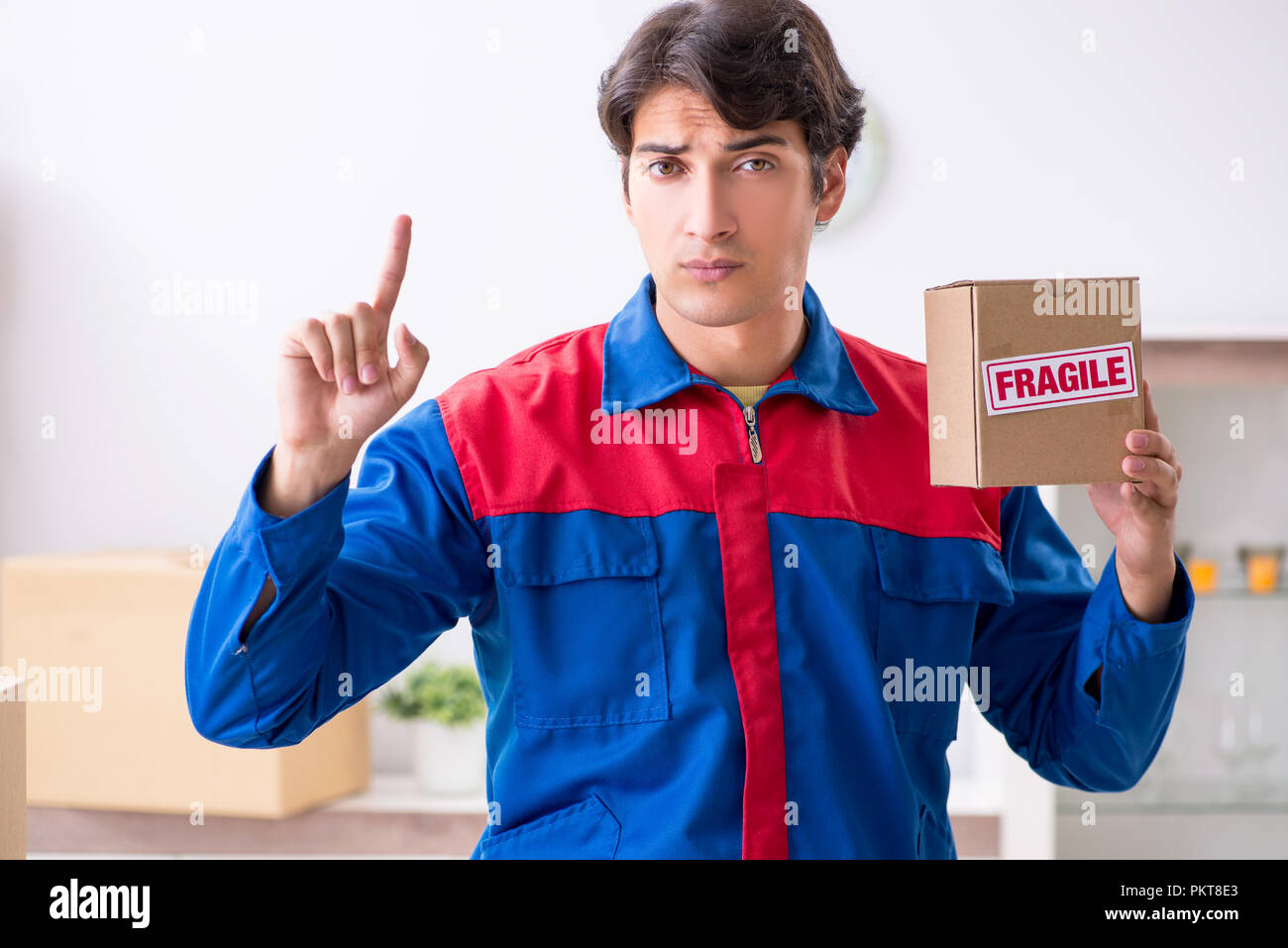 Transportation contractor with fragile boxes Stock Photo - Alamy