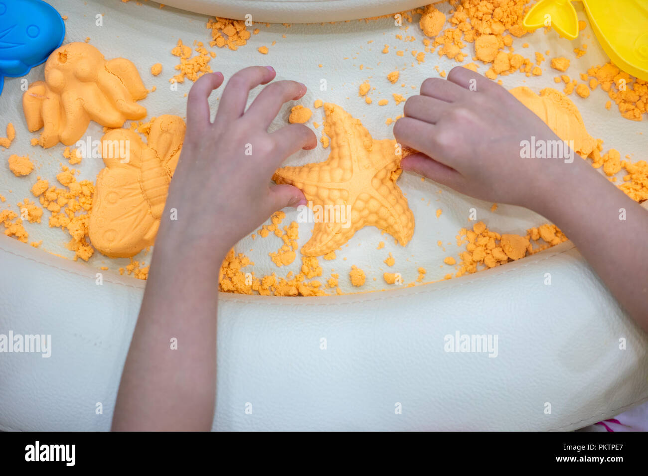 Children's Hands Playing Kinetic Sand At Indoor Playground Stock Photo ...