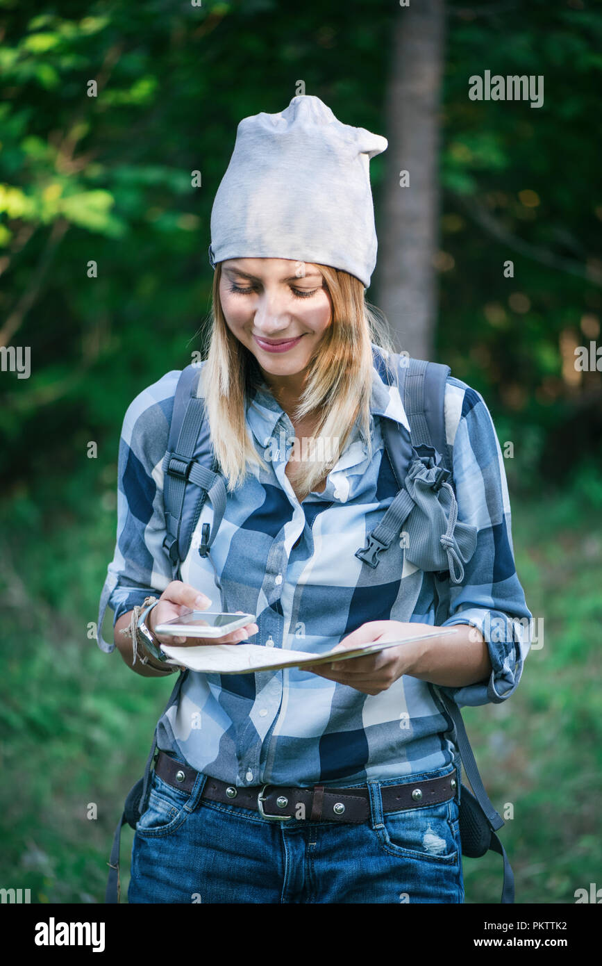Young woman reading map in mountain Stock Photo - Alamy