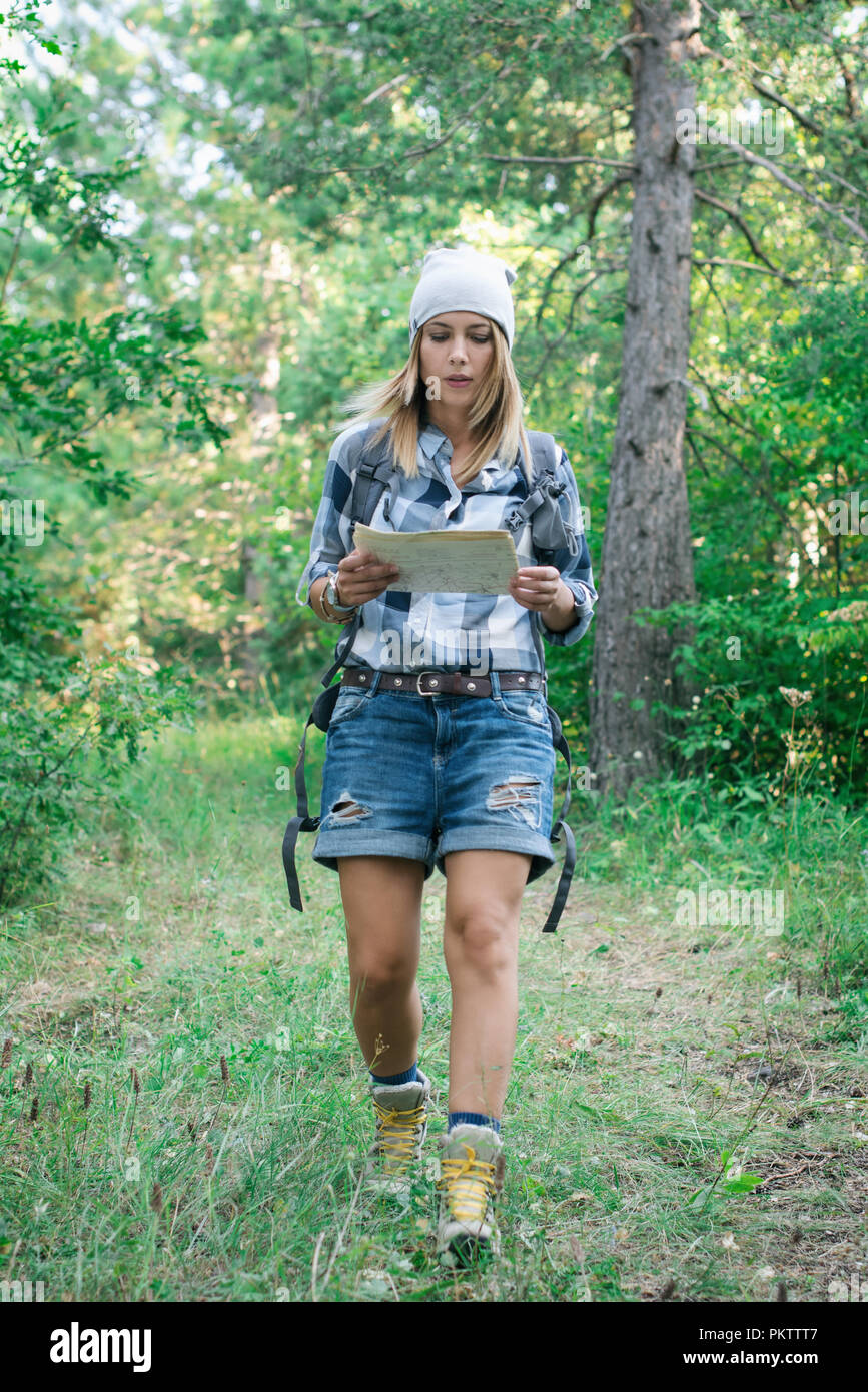 Young woman reading map in mountain Stock Photo - Alamy
