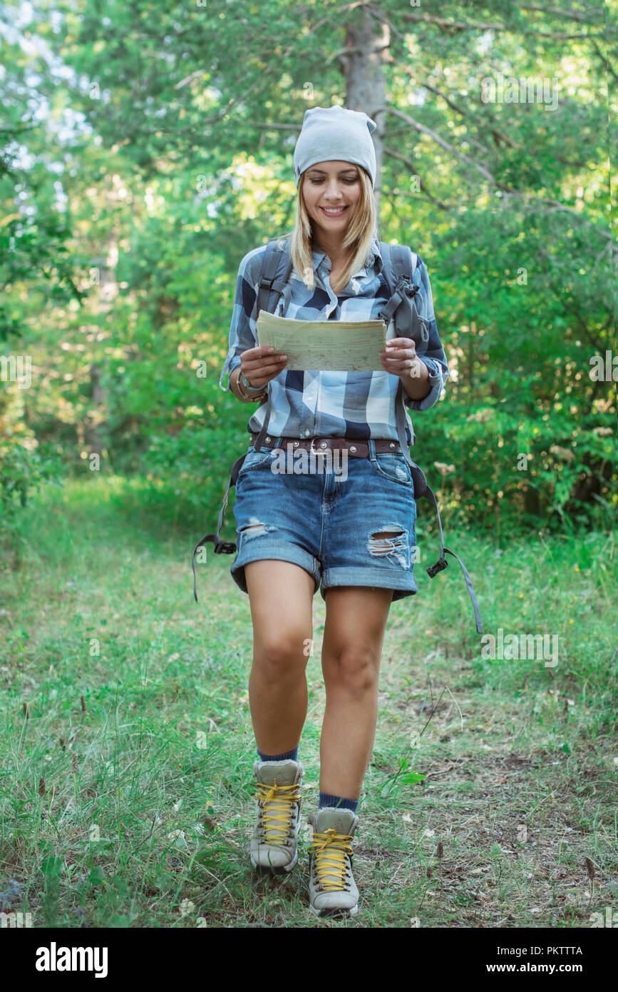 Young woman reading map in mountain Stock Photo - Alamy