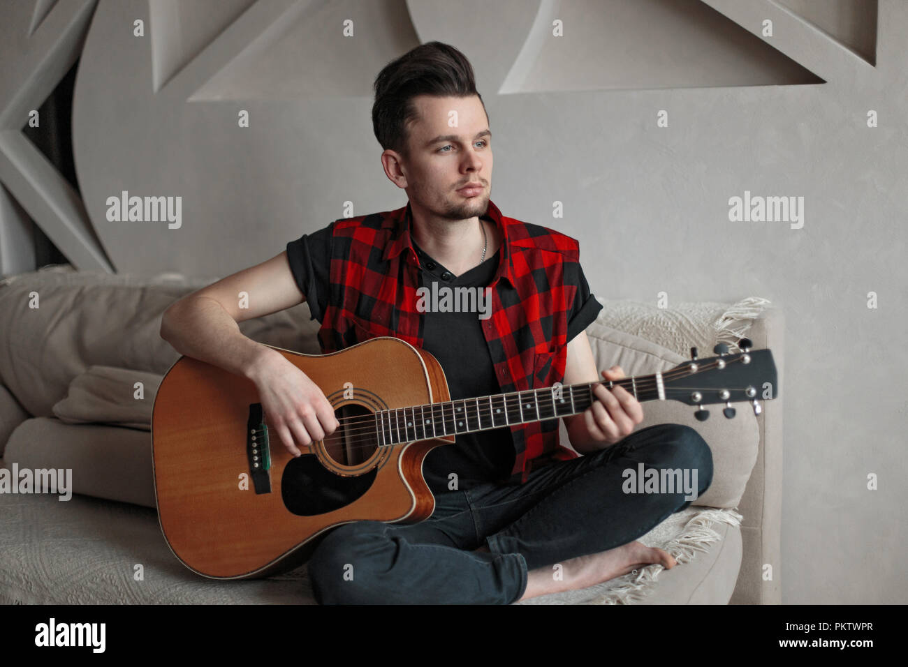 Young musician guy playing the guitar Stock Photo - Alamy