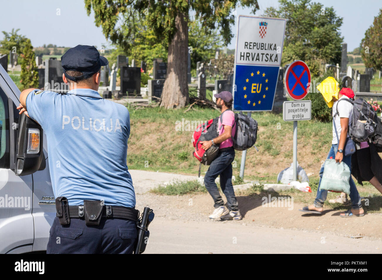 TOVARNIK, CROATIA - SEPTEMBER 19, 2015: Croatian police officer looking ...