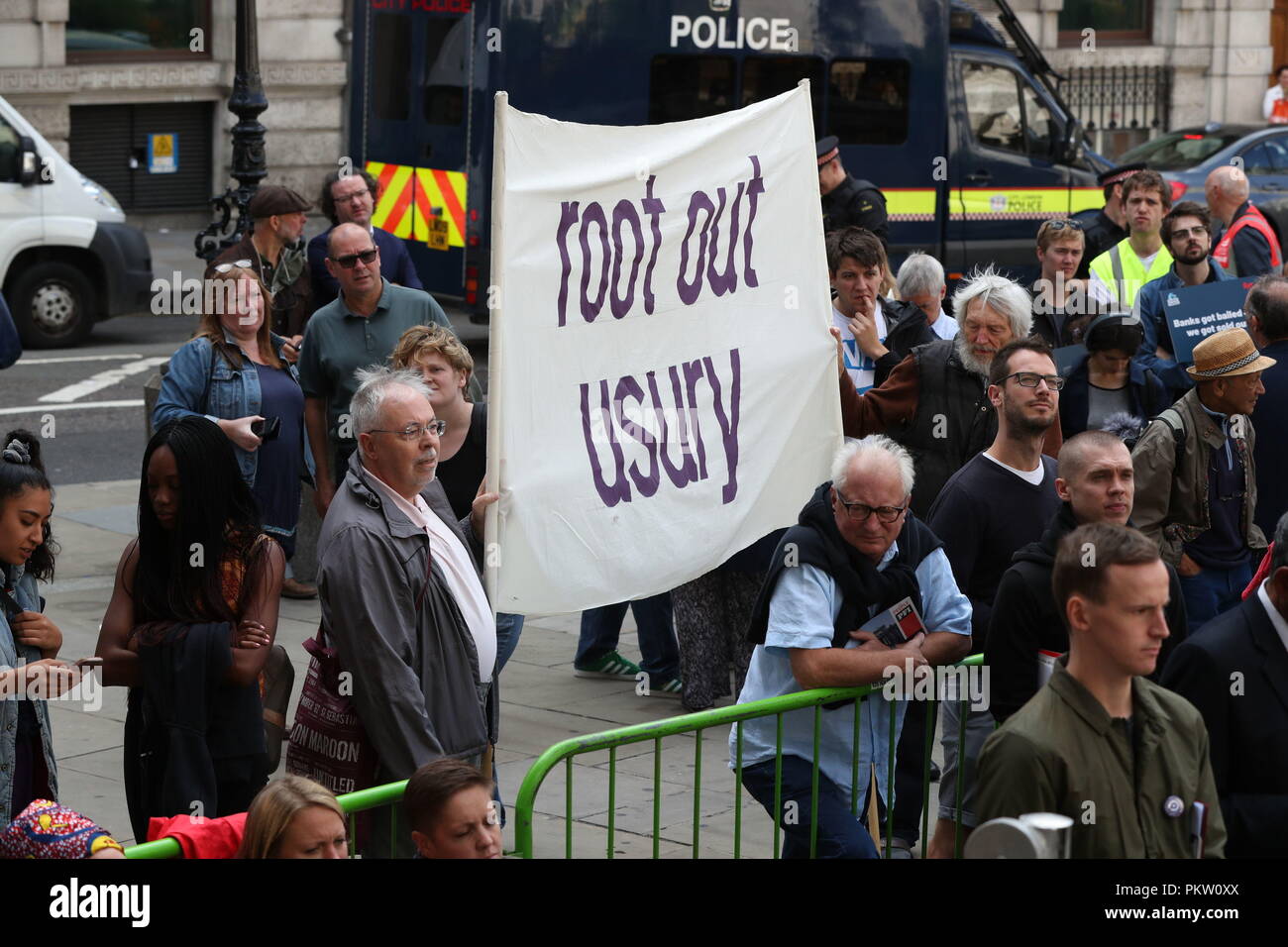 Protesters hold a banner at a rally to mark the 10th anniversary of the ...