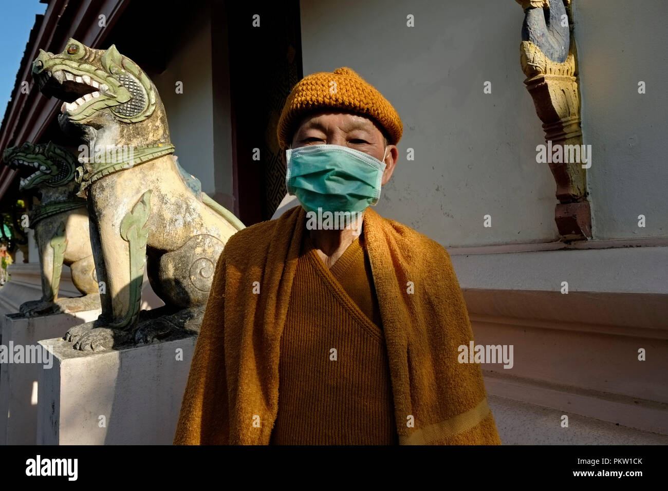 A Buddhist monk wearing a surgical mask at Sri Khun Muane temple in the ...