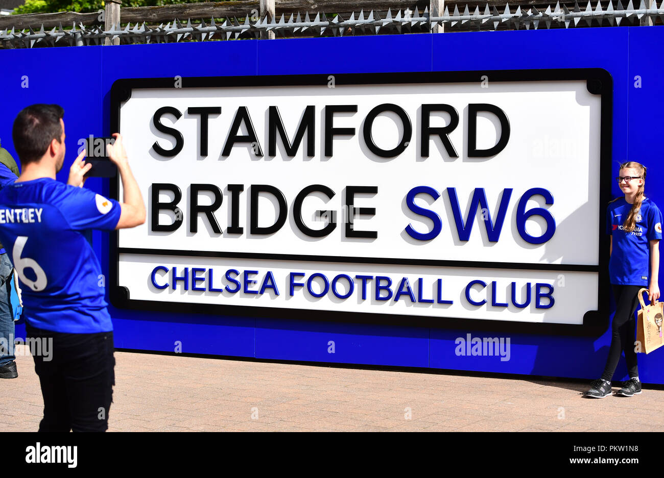 A young Chelsea fan poses for a picture by a Stamford Bridge sign prior ...