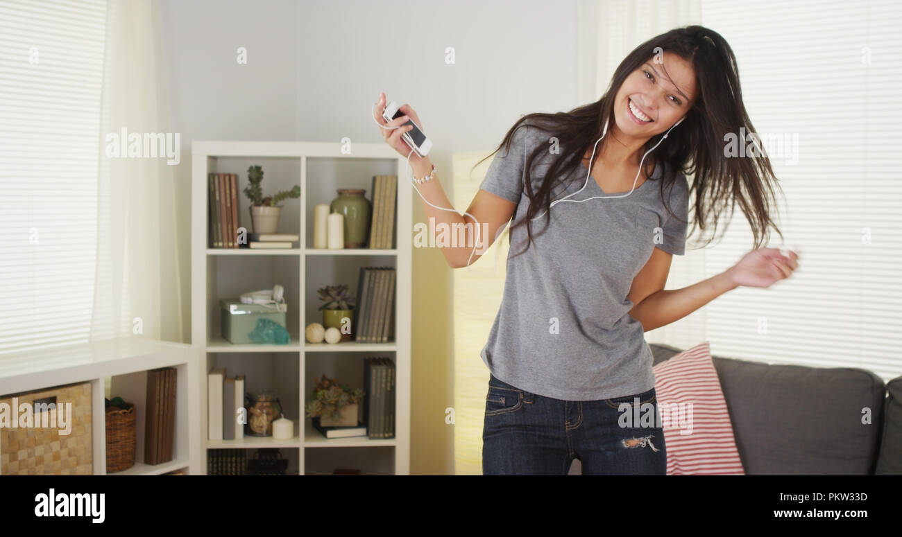 Happy woman dancing with her mp3 player Stock Photo - Alamy