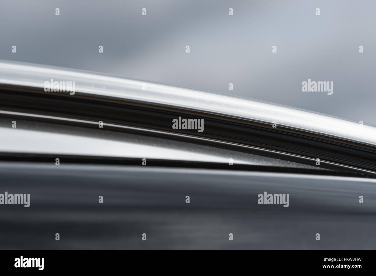 Close-up, abstract view of an SUVs chrome roof rack shown with some of ...