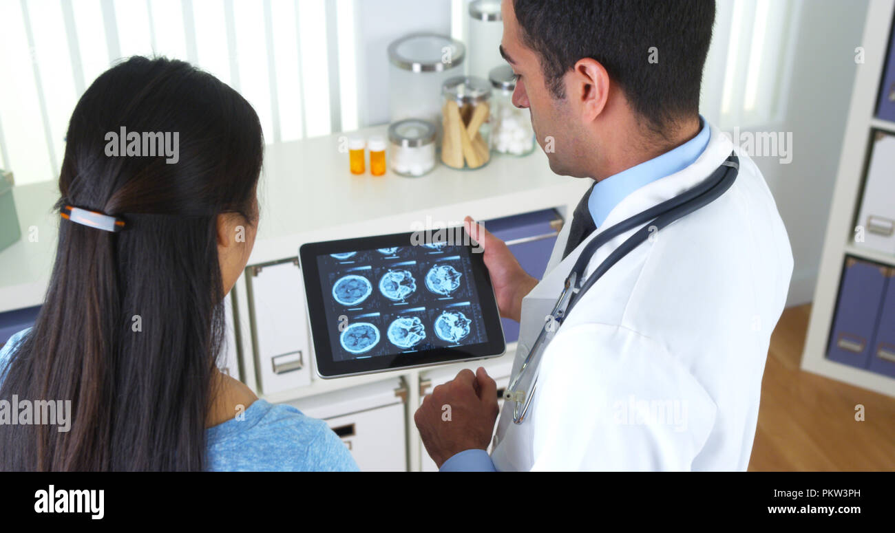 Mexican doctor explaining brain scans to patient Stock Photo - Alamy