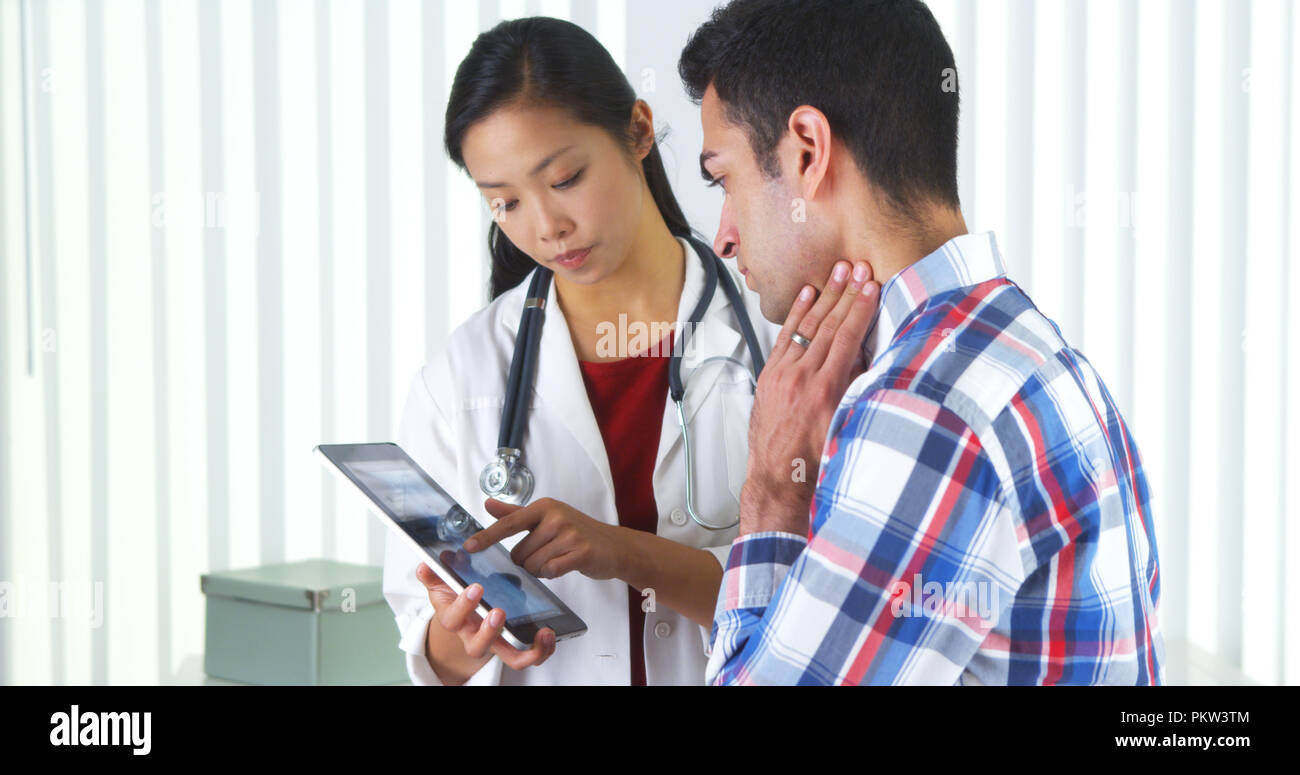 Hispanic patient listening to doctor talk about x-ray Stock Photo - Alamy