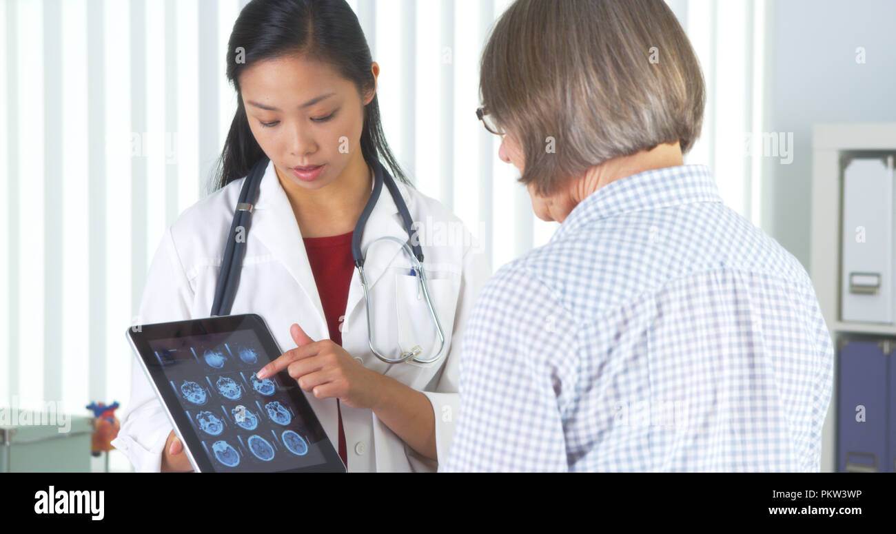 Chinese doctor talking to patient about xrays Stock Photo - Alamy