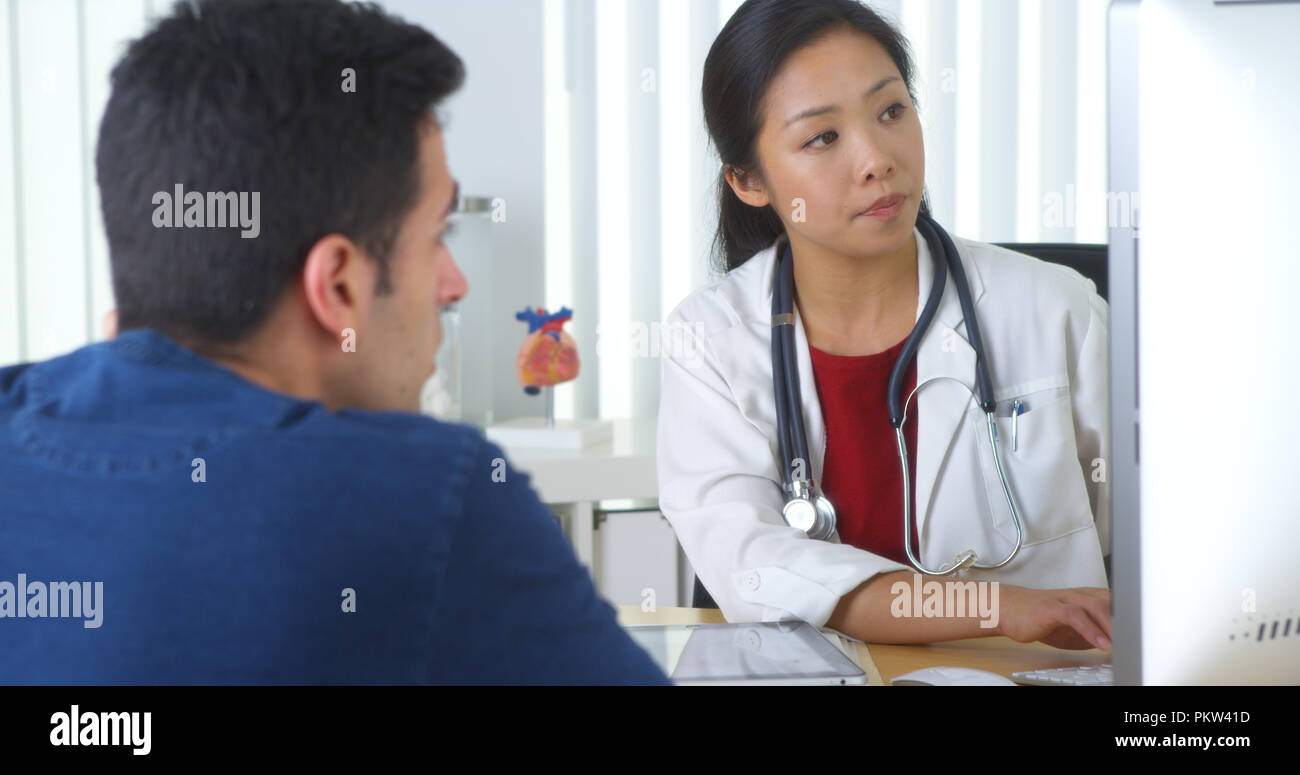 Chinese doctor explaining xray to patient Stock Photo - Alamy
