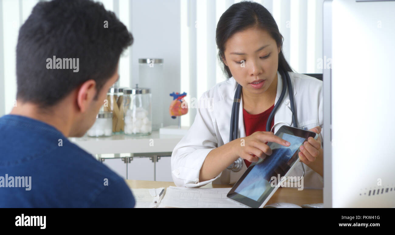 Chinese doctor explaining xray to patient Stock Photo - Alamy