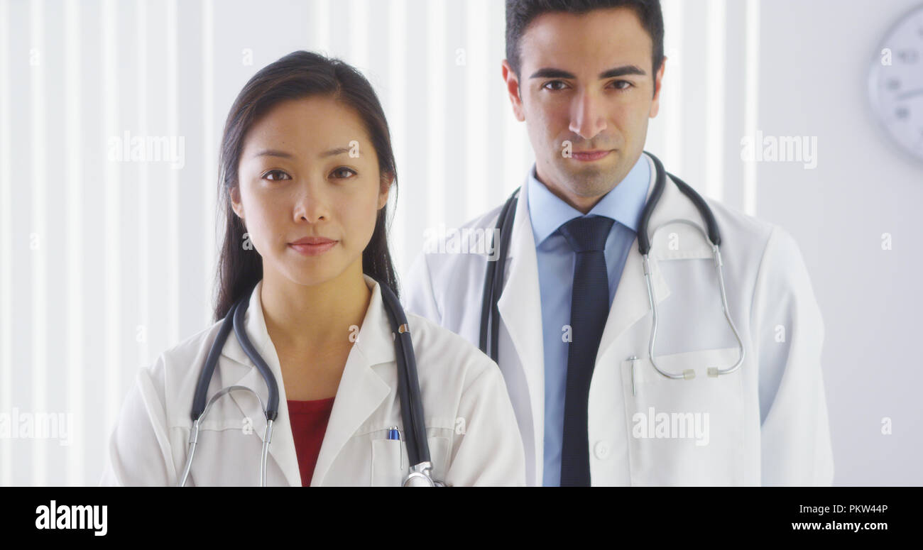 Two serious doctors looking at camera Stock Photo - Alamy
