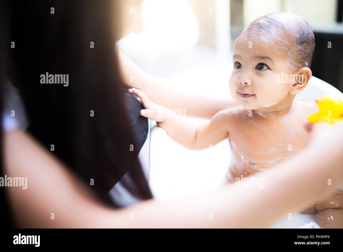 Asia mother bathing baby in the small plastic bath Stock Photo - Alamy