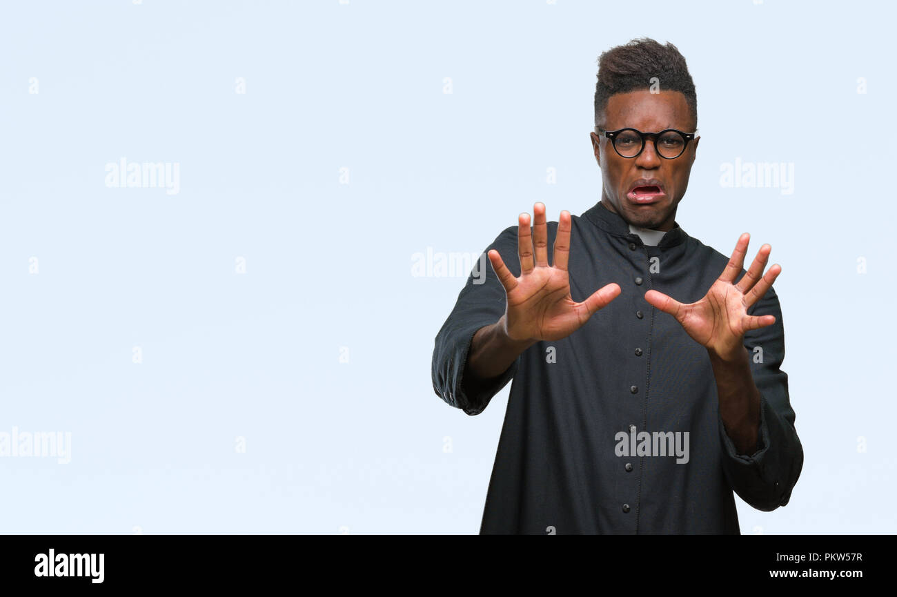 Young african american priest man over isolated background afraid and ...