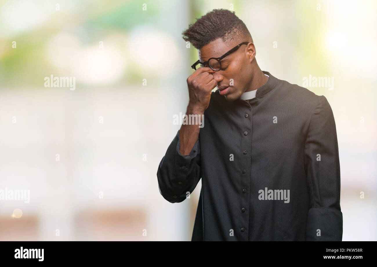 Young african american priest man over isolated background tired ...