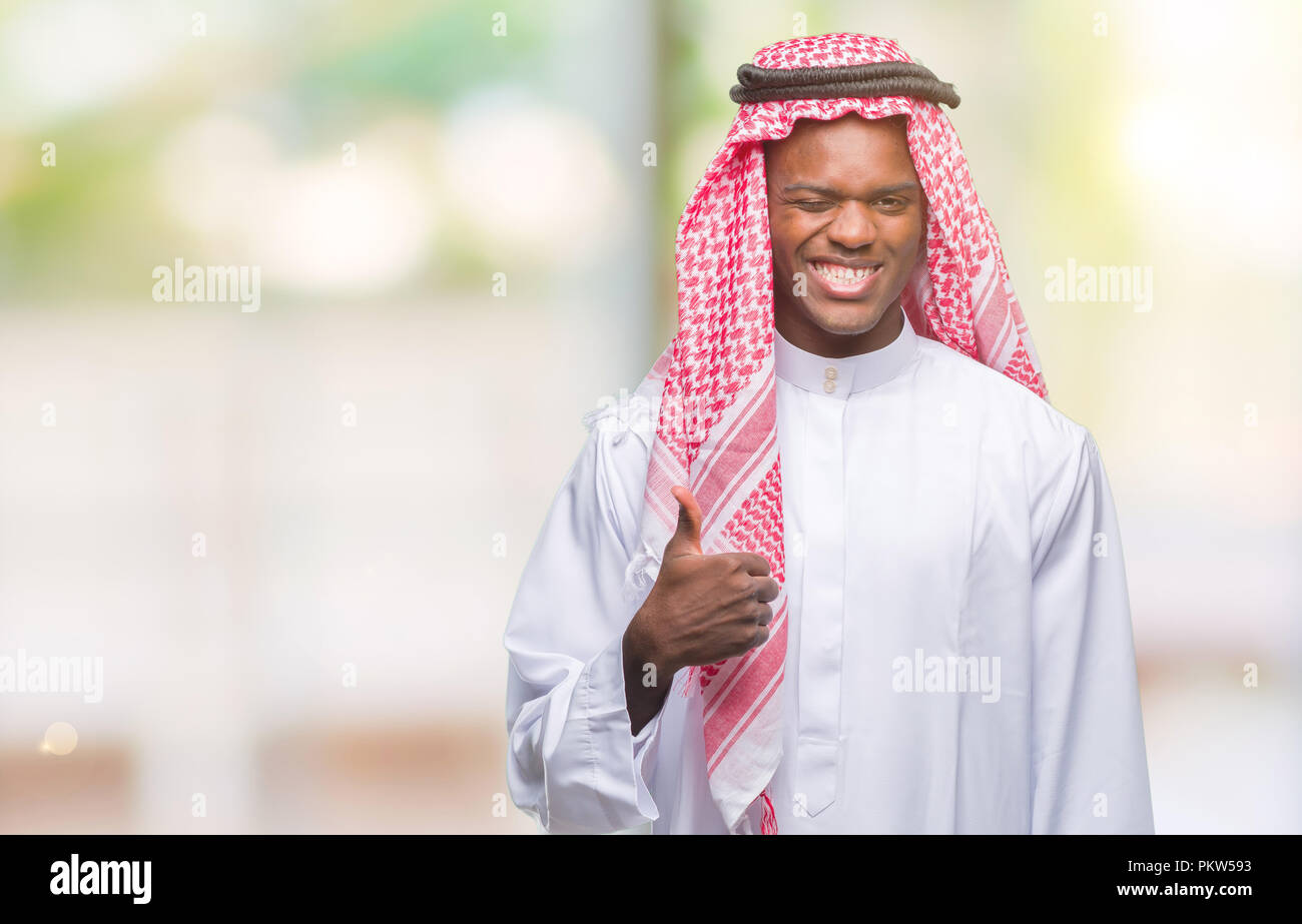 Young arabic african man wearing traditional keffiyeh over isolated ...