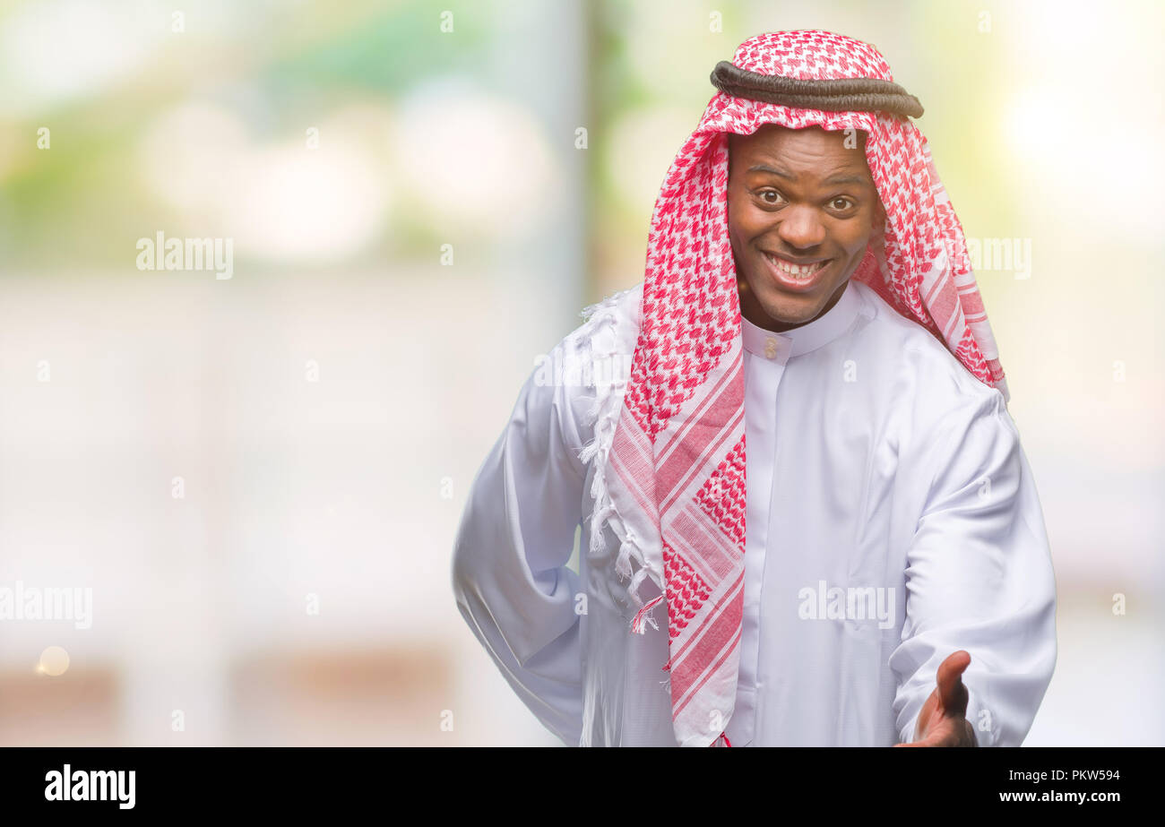 Young arabic african man wearing traditional keffiyeh over isolated ...