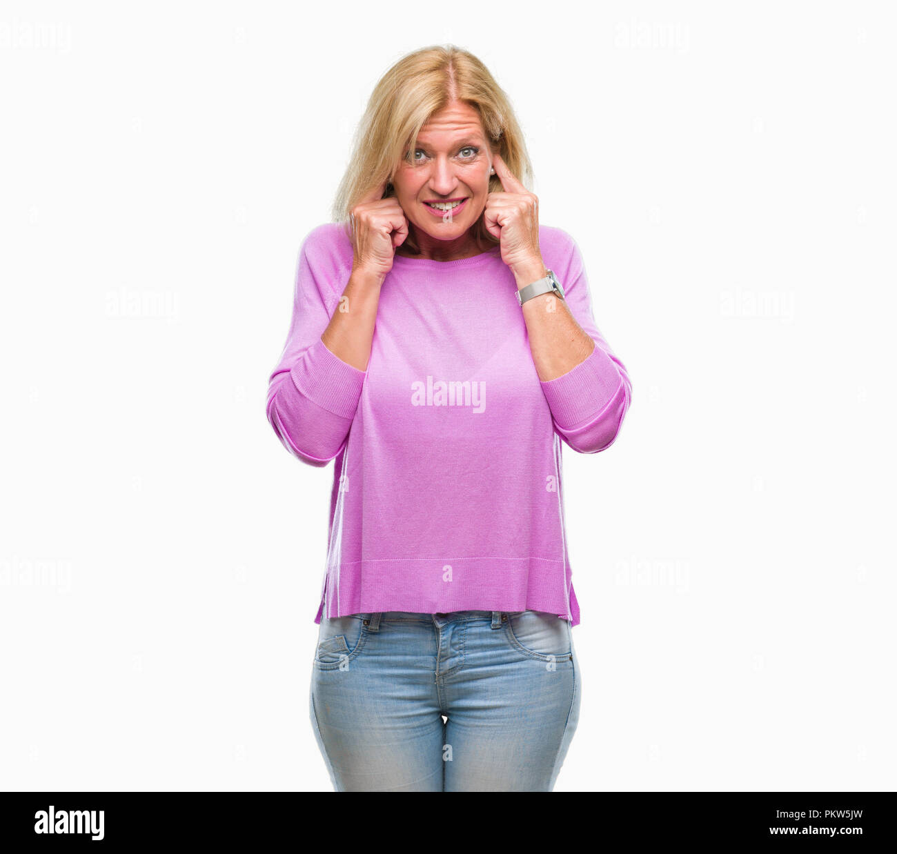 Middle age blonde woman over isolated background covering ears with ...