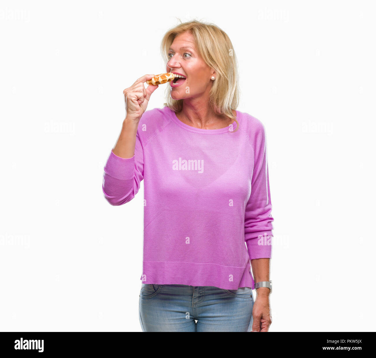 Middle age blonde woman eating sweet waffle over isolated background ...