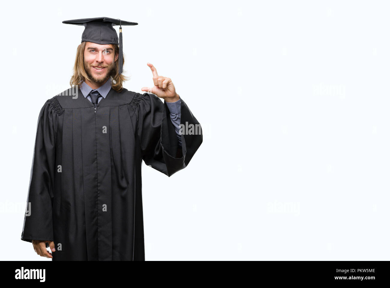 Young handsome graduated man with long hair over isolated background ...