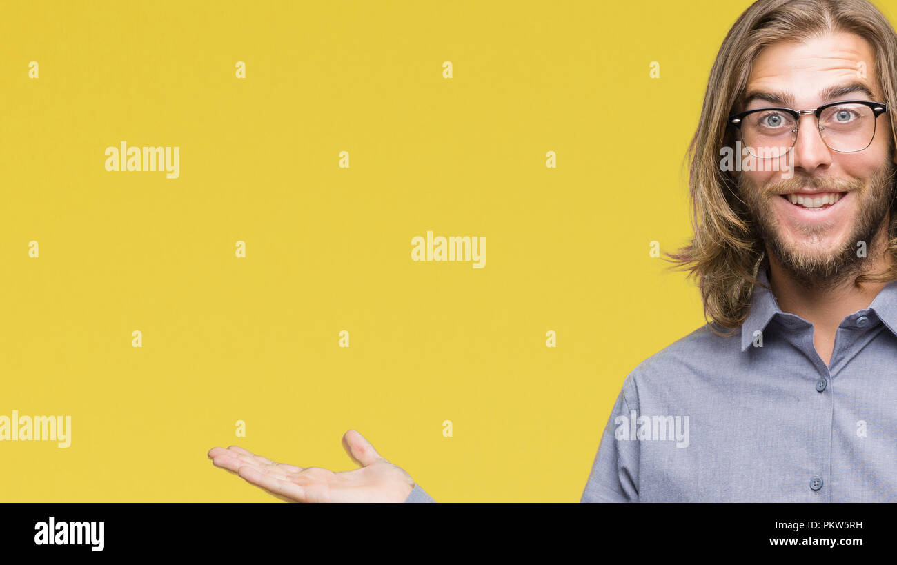 Young handsome business man with long hair over isolated background ...