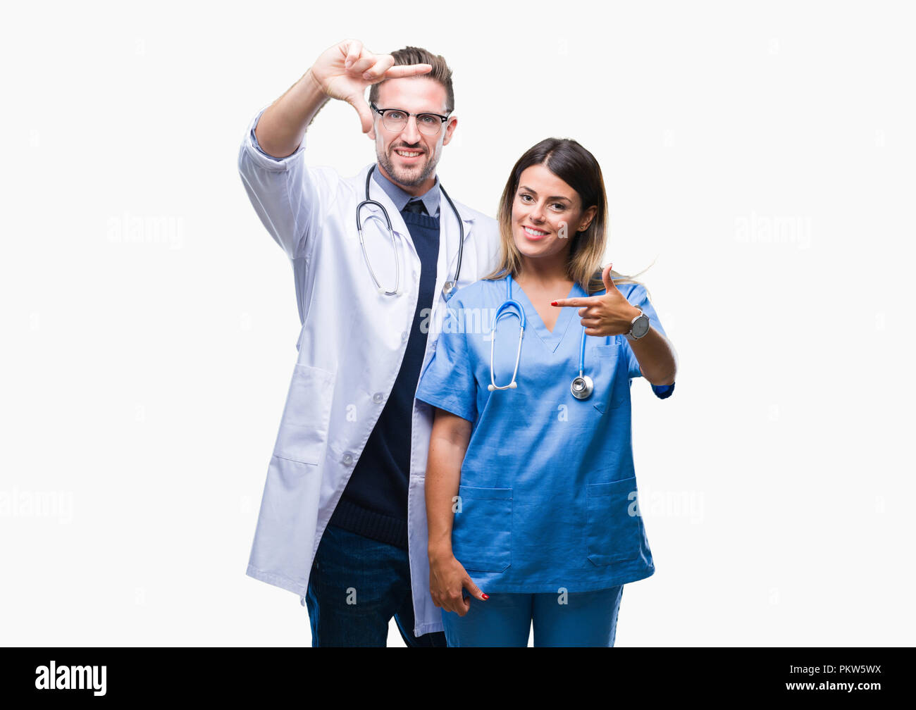 Young couple of doctor and surgeon over isolated background smiling ...