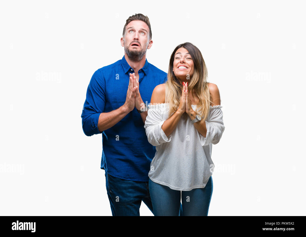 Young couple in love over isolated background begging and praying with ...