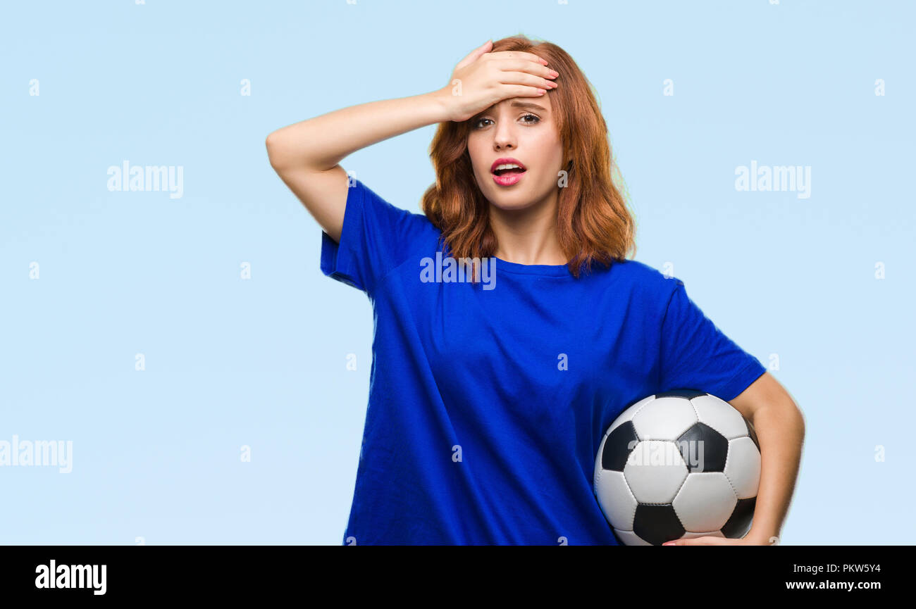 Young beautiful woman over isolated background holding soccer football ...