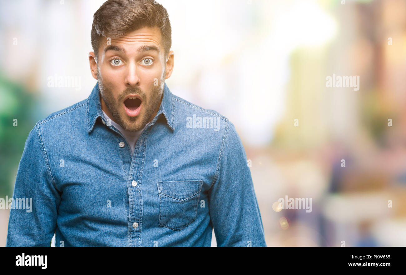 Young handsome man over isolated background afraid and shocked with surprise expression, fear ...