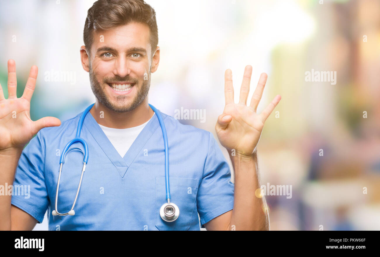 Young handsome doctor surgeon man over isolated background showing and ...