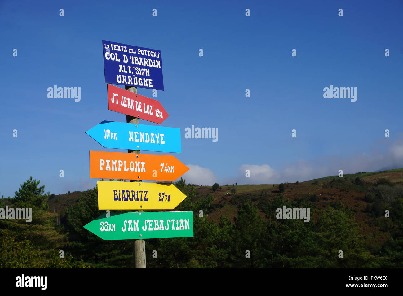 Colorful signs at the top of a Spanish pass showing the direction and ...