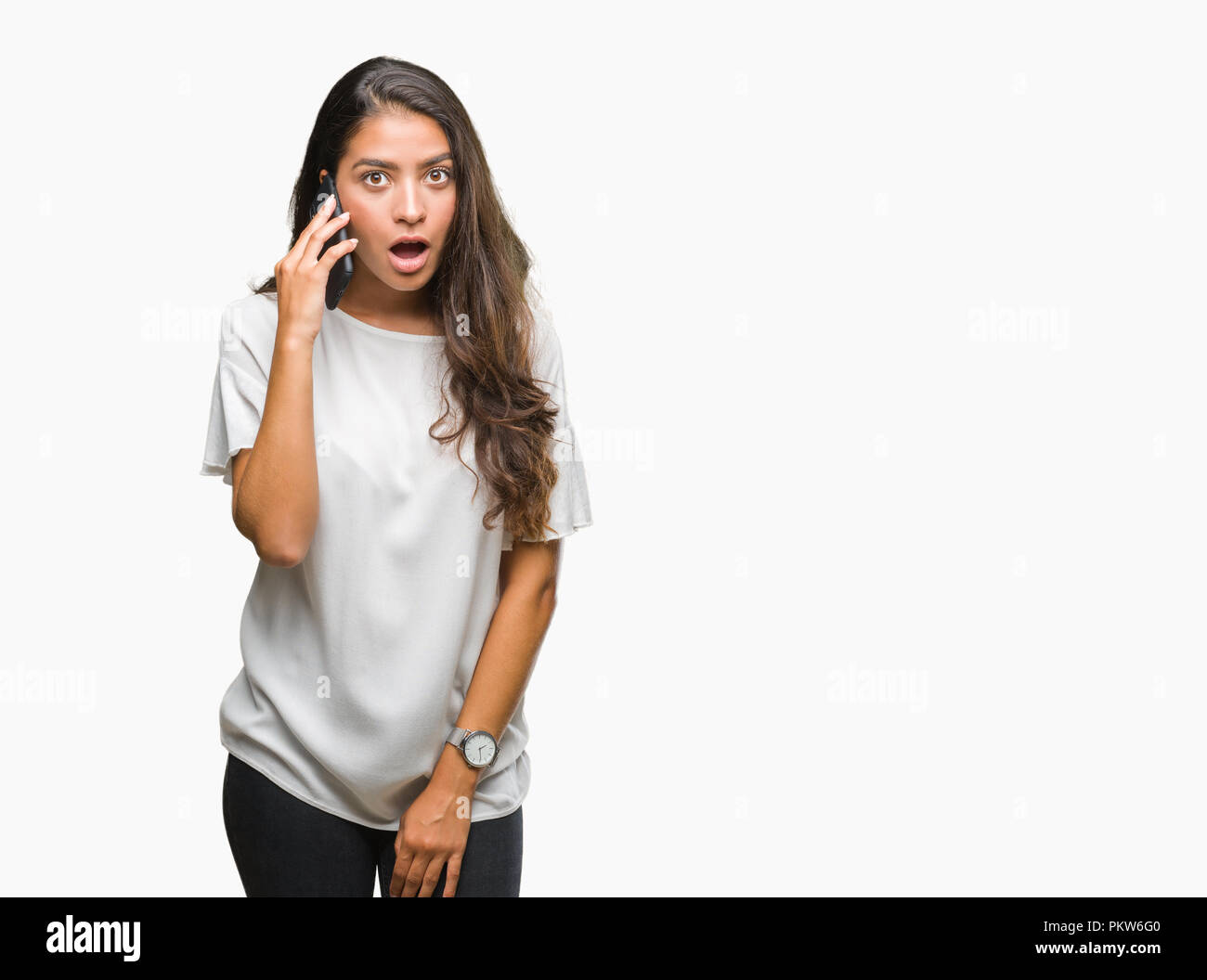 Young beautiful arab woman talking on the phone over isolated ...