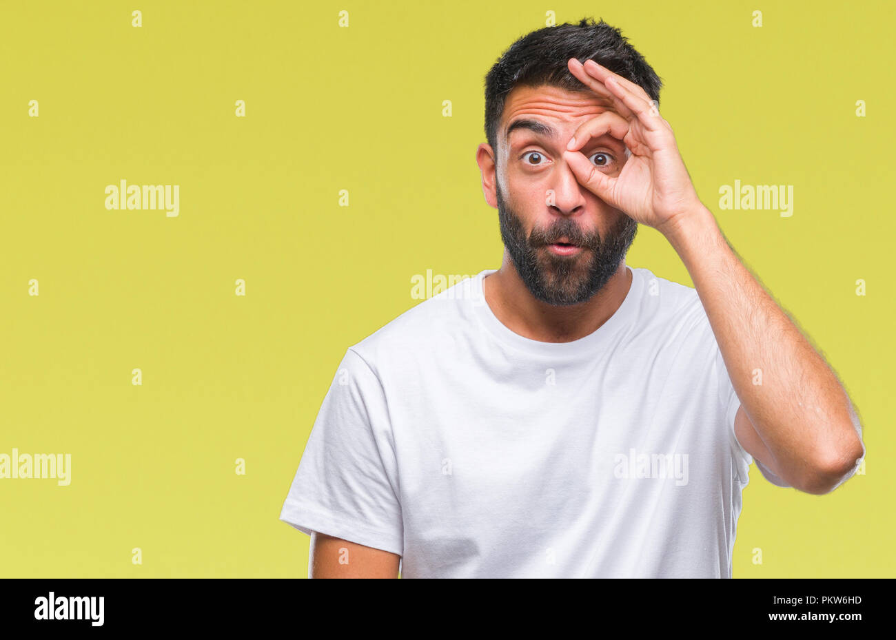 Adult hispanic man over isolated background doing ok gesture shocked ...