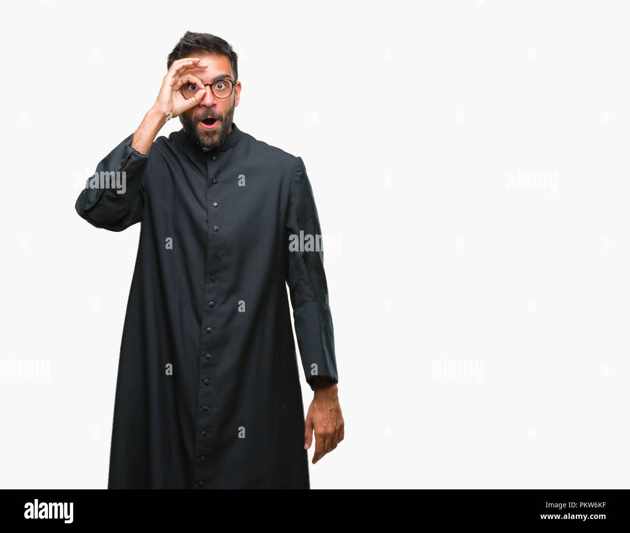 Adult hispanic catholic priest man over isolated background doing ok ...