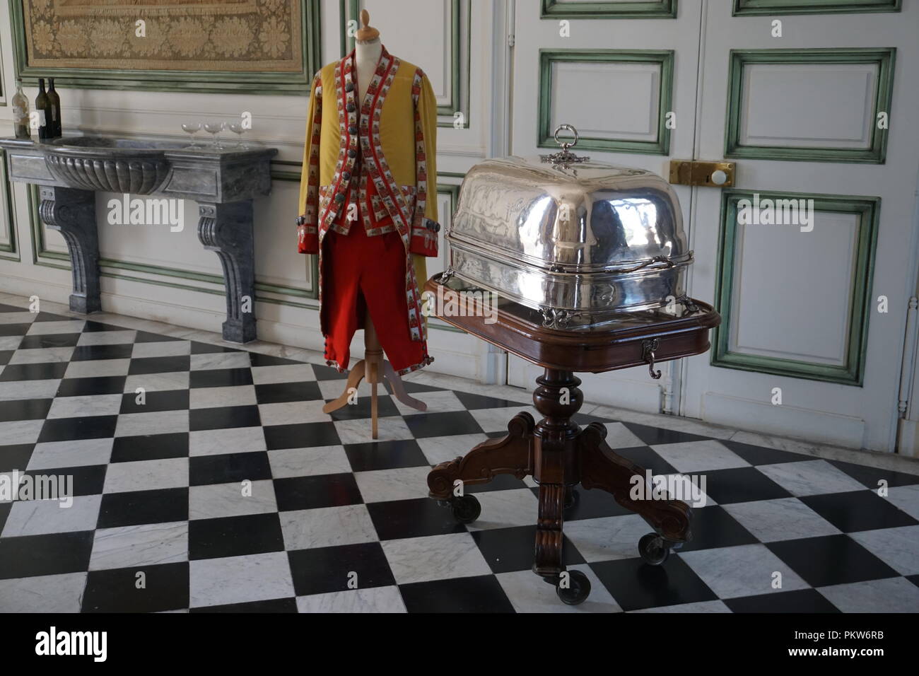Black and white checker tile floor in the castle with a dummy in full ...