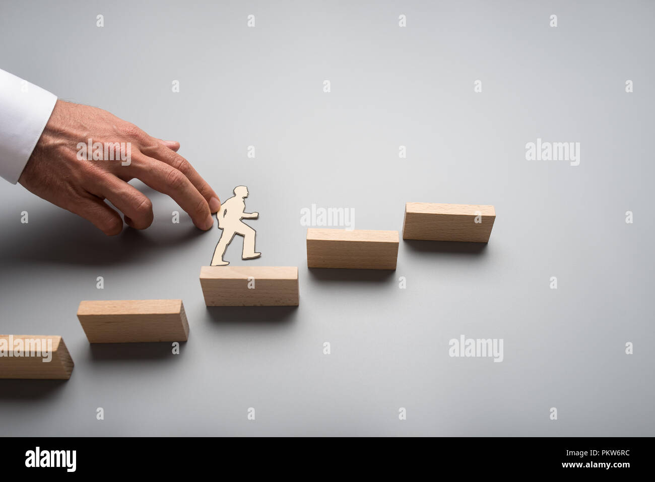 Businessman climbing up the steps to success and advancement in a ...