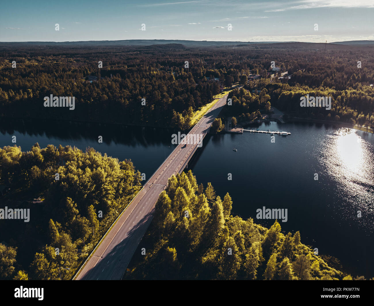 Bridge over water at Hyrynsalmi Finland with sunshine and some ...