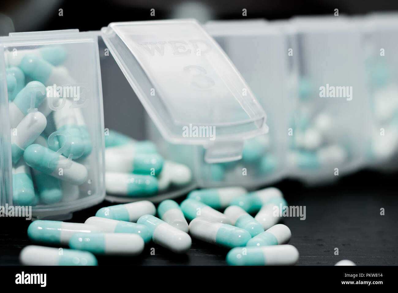 A weekly dosage of medication in pill dispenser. Selective focus Stock ...