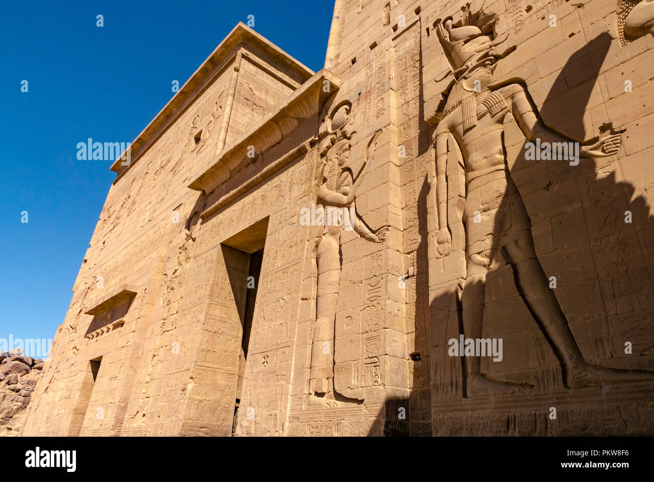 Outer pylon and gateway with carved Egyptian figures hieroglyphs ...