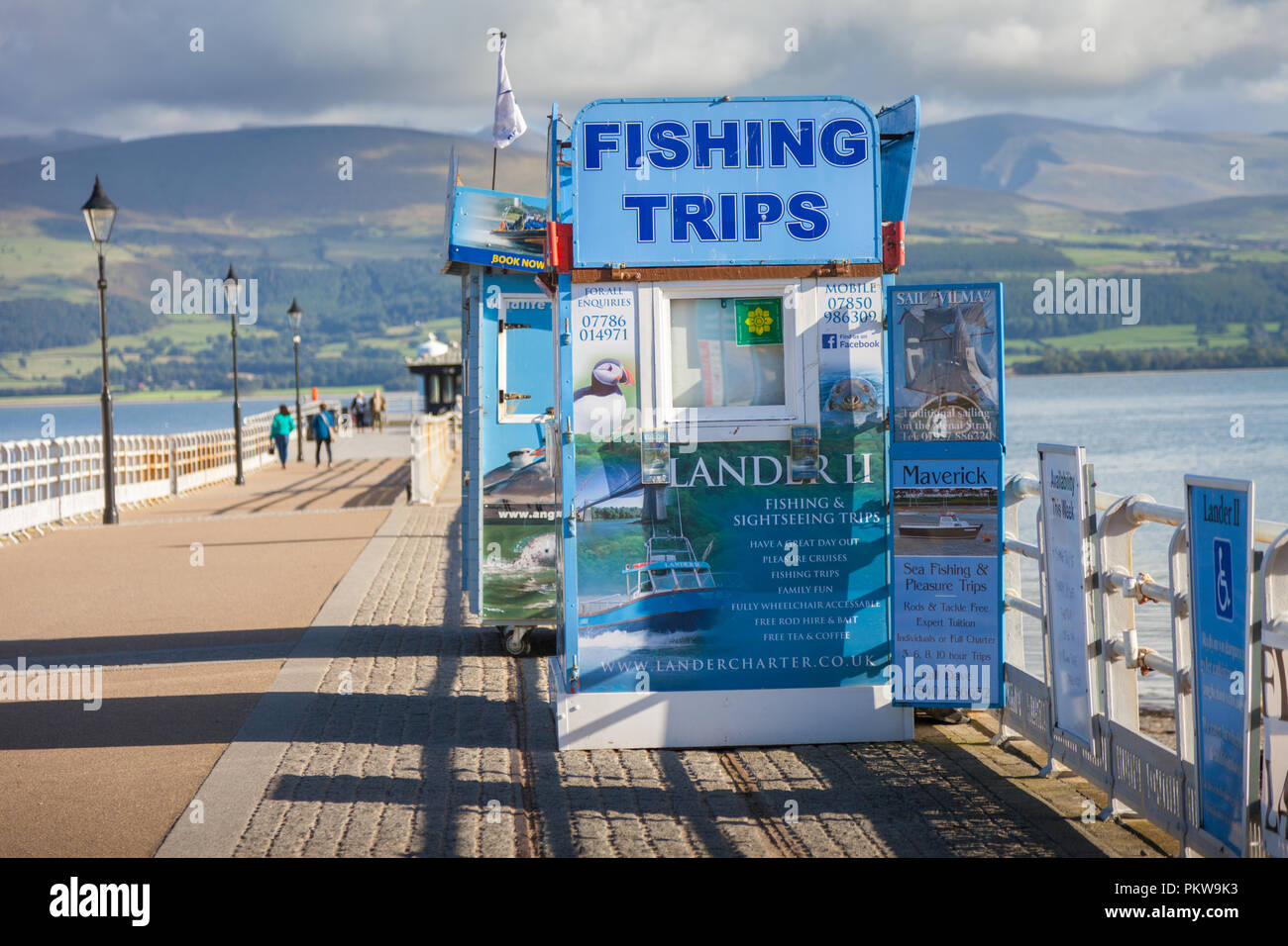 Fishing trips kiosk on the pier at Beaumaris, Anglesey, UK Stock Photo ...