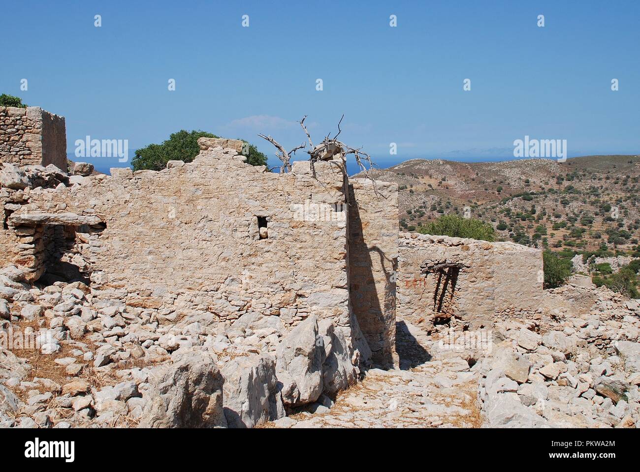 The ruins of the abandoned village of Mikro Chorio on the Greek island ...